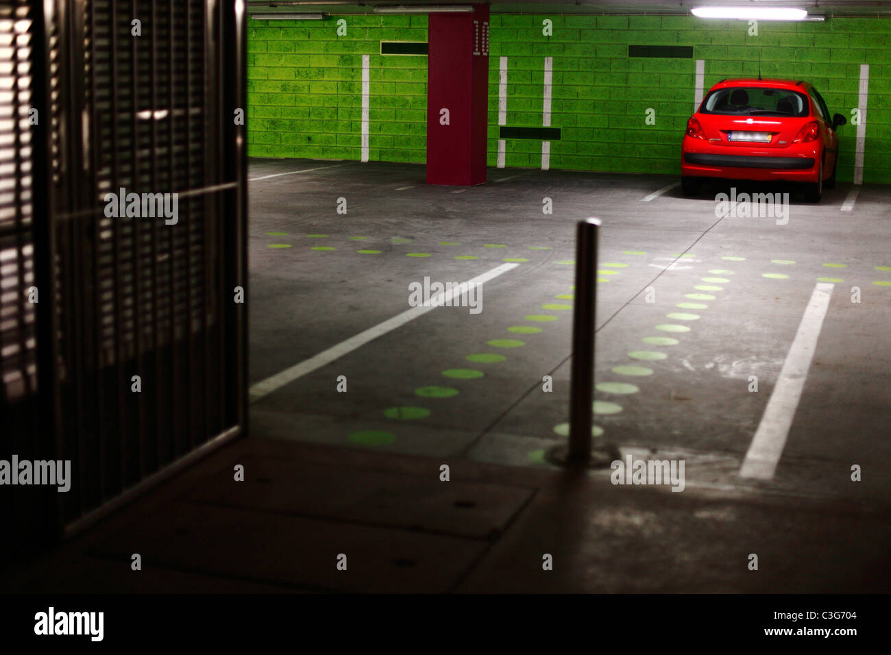 Red car in underground parking lot Stock Photo - Alamy