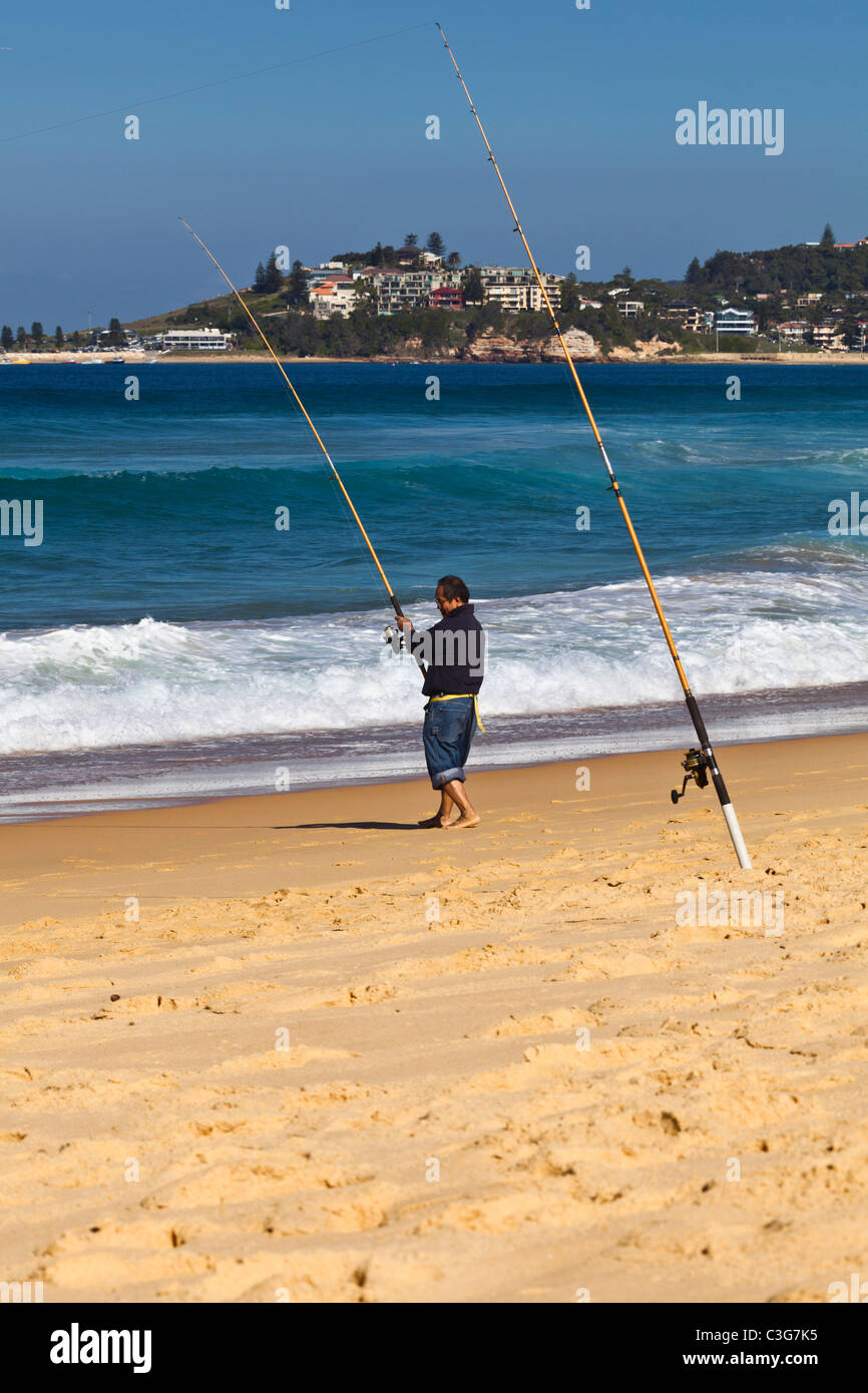 A beach fisherman with 2 rods Stock Photo - Alamy