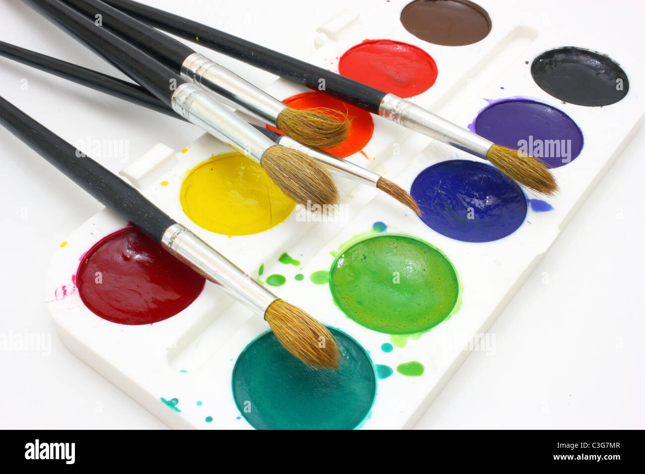 Dirty watercolor paints set with brushes after using Stock Photo - Alamy