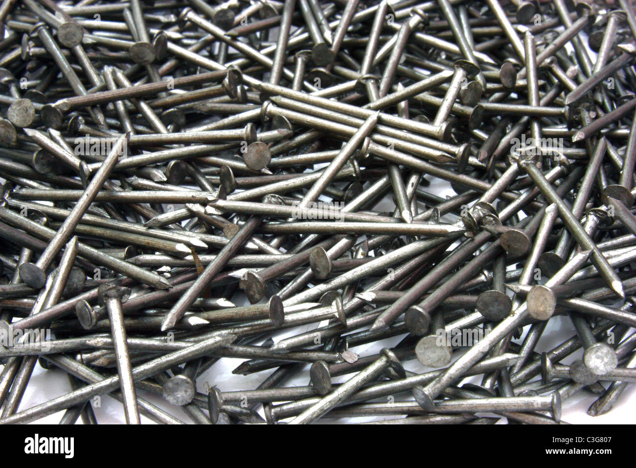 metal different nails on white background Stock Photo - Alamy