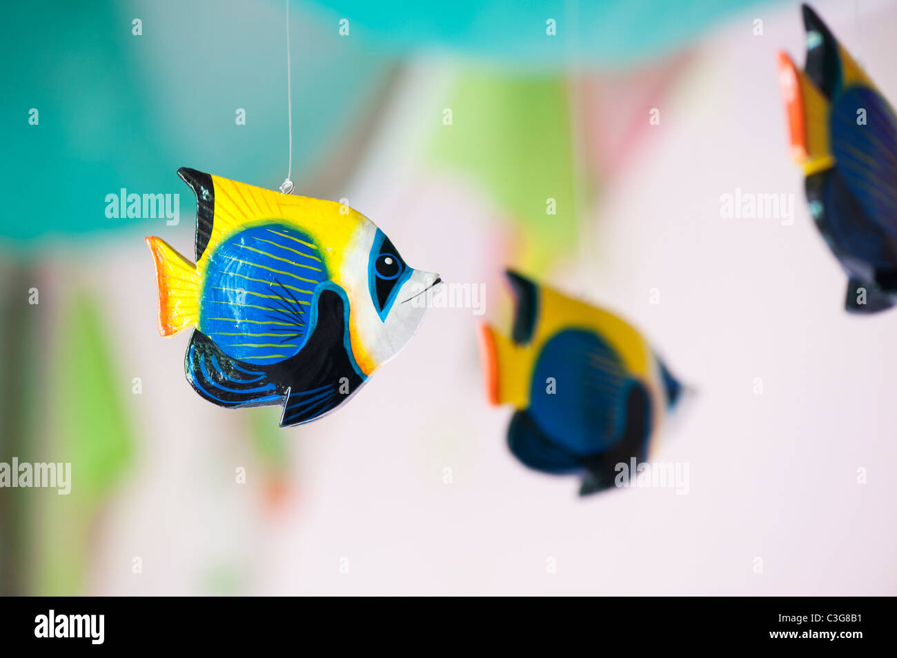 Colourful hanging wooden fish mobile. UK Stock Photo - Alamy