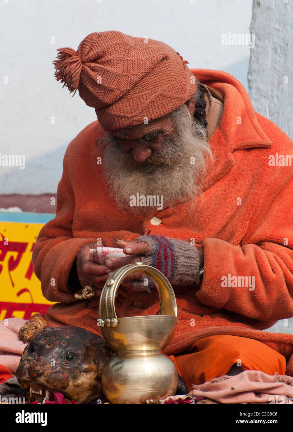 Sadhu counting his takings at the Bindhya Basini Mandir Temple in ...