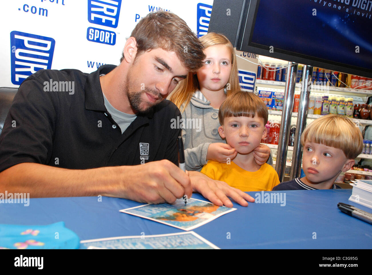 Michael Phelps signs autographs for fans at the GNC store in the Ross ...