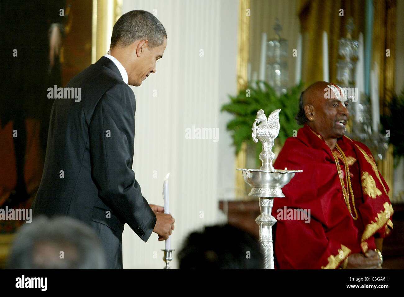 President Barack Obama lights a candle President Barack Obama signs an ...