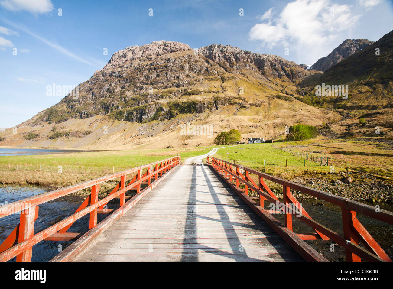 A bridge crossing the River Coe in Glen Coe, looking up to the summit ...