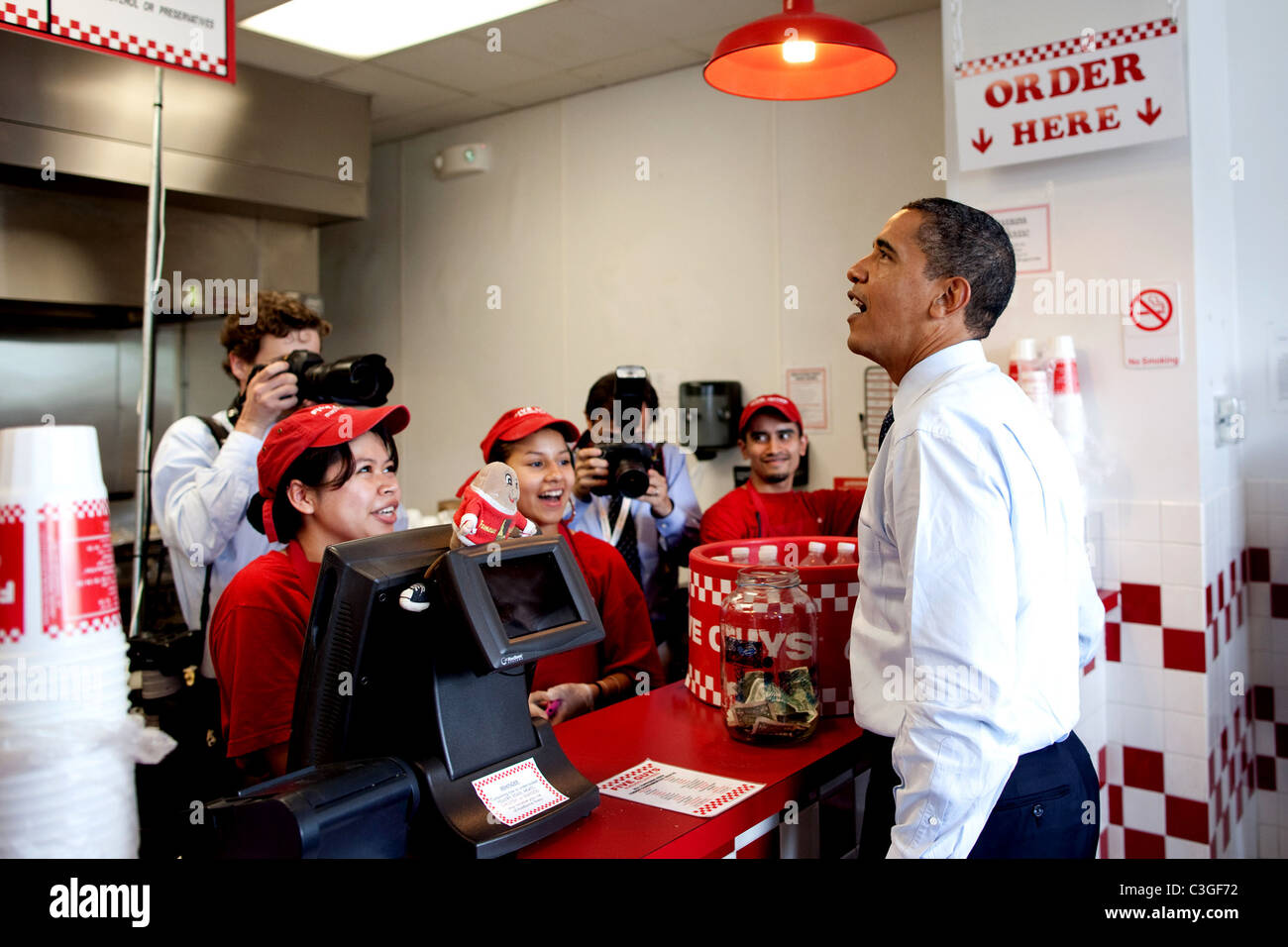 President Barack Obama walks towards the entrance of Five Guys in ...
