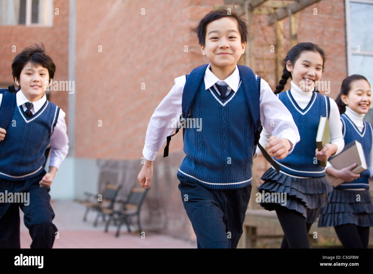 Five classmates running through campus Stock Photo - Alamy