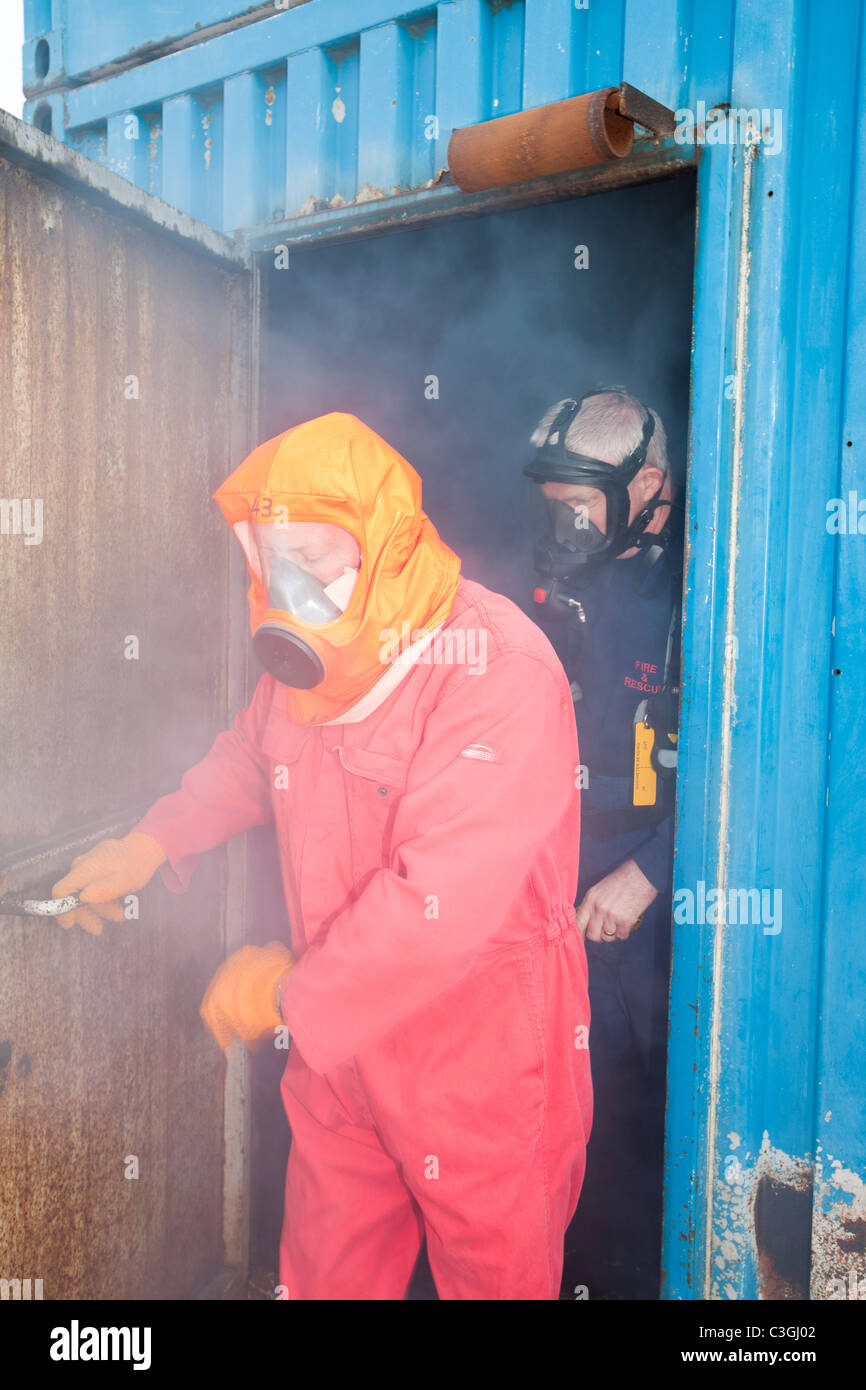 Workers in the offshore industry practice escaping from a smoke chamber ...