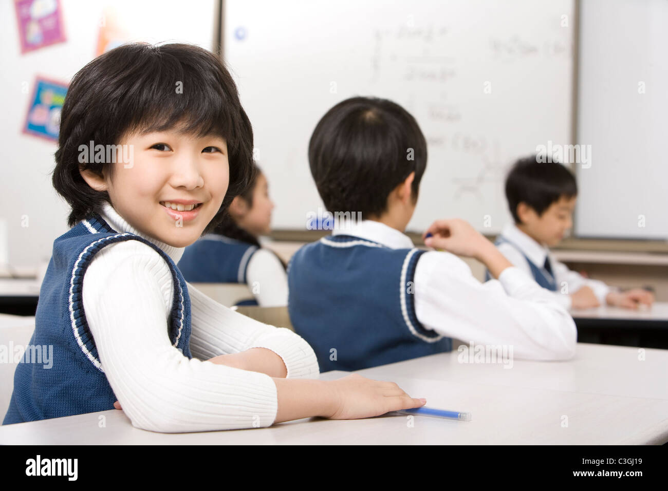 Young student sitting at her desk in the classroom Stock Photo - Alamy