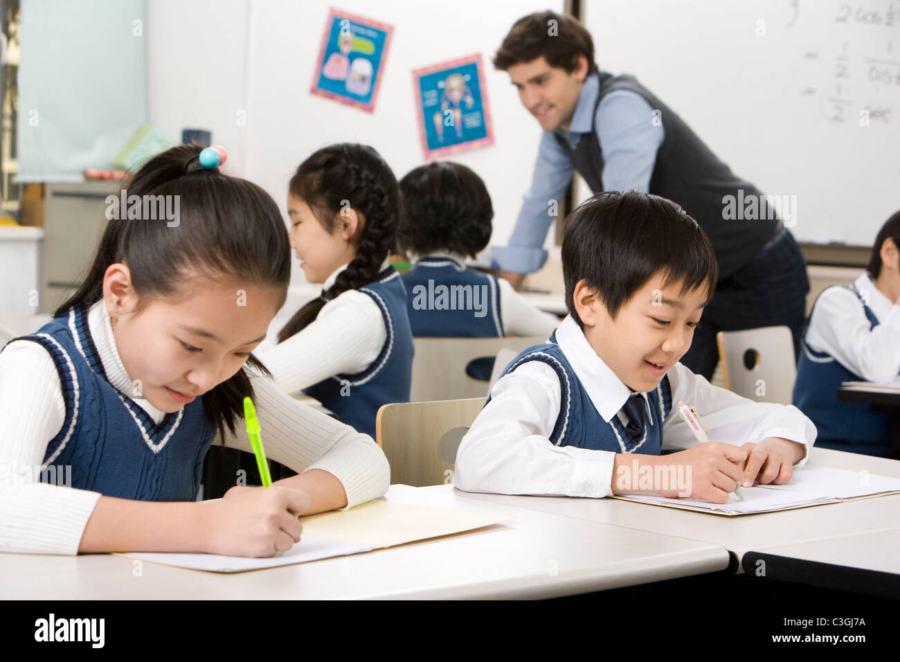 Students writing in class Stock Photo - Alamy