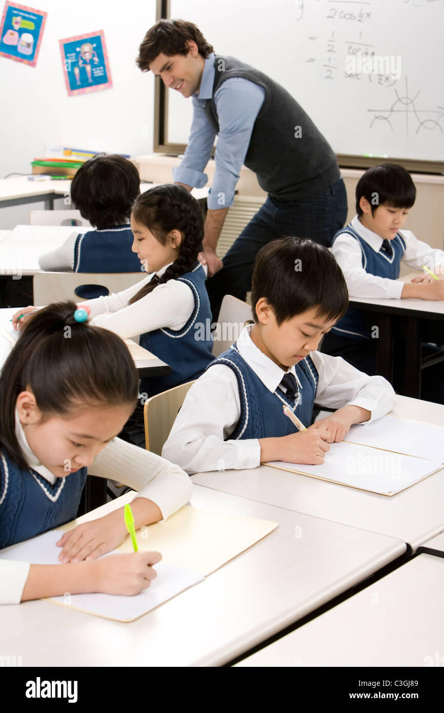 Students writing in class Stock Photo - Alamy