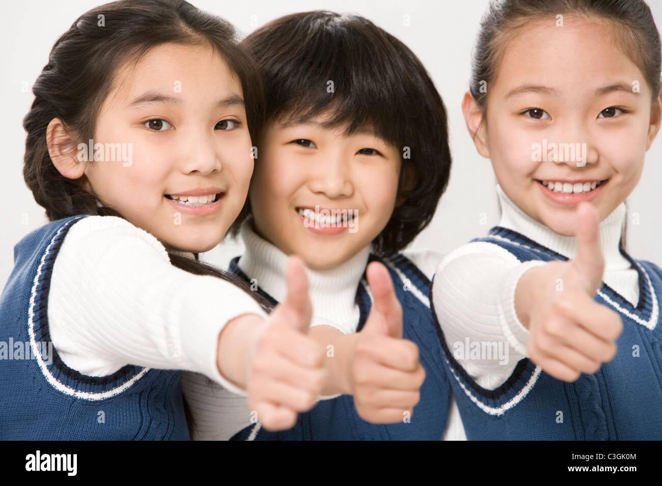Students giving thumbs-up in the classroom Stock Photo - Alamy