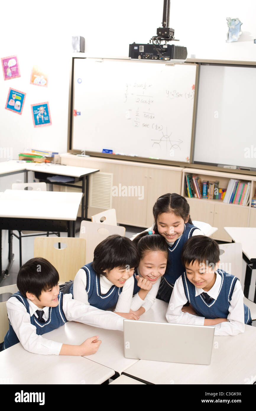 Schoolboy In Classroom With Hand On Chin High Resolution Stock ...