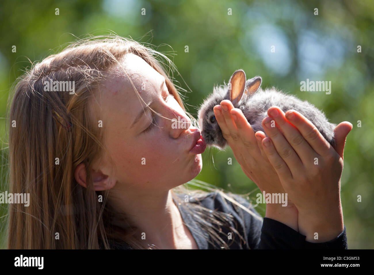 young girl kissing a young rabbit Stock Photo - Alamy