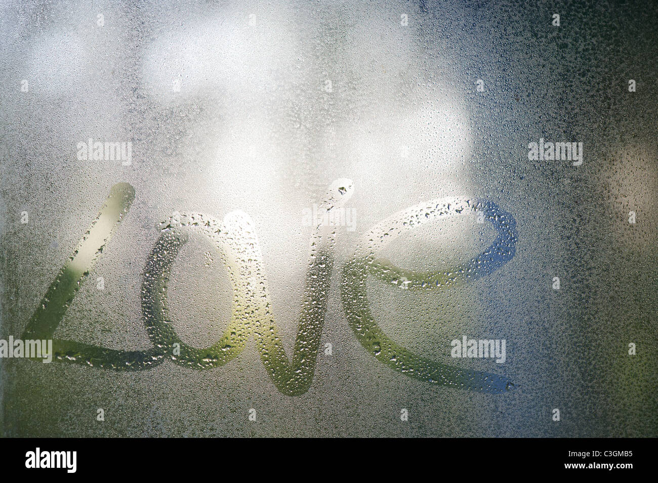 Love written in condensation on a glass window pane Stock Photo - Alamy