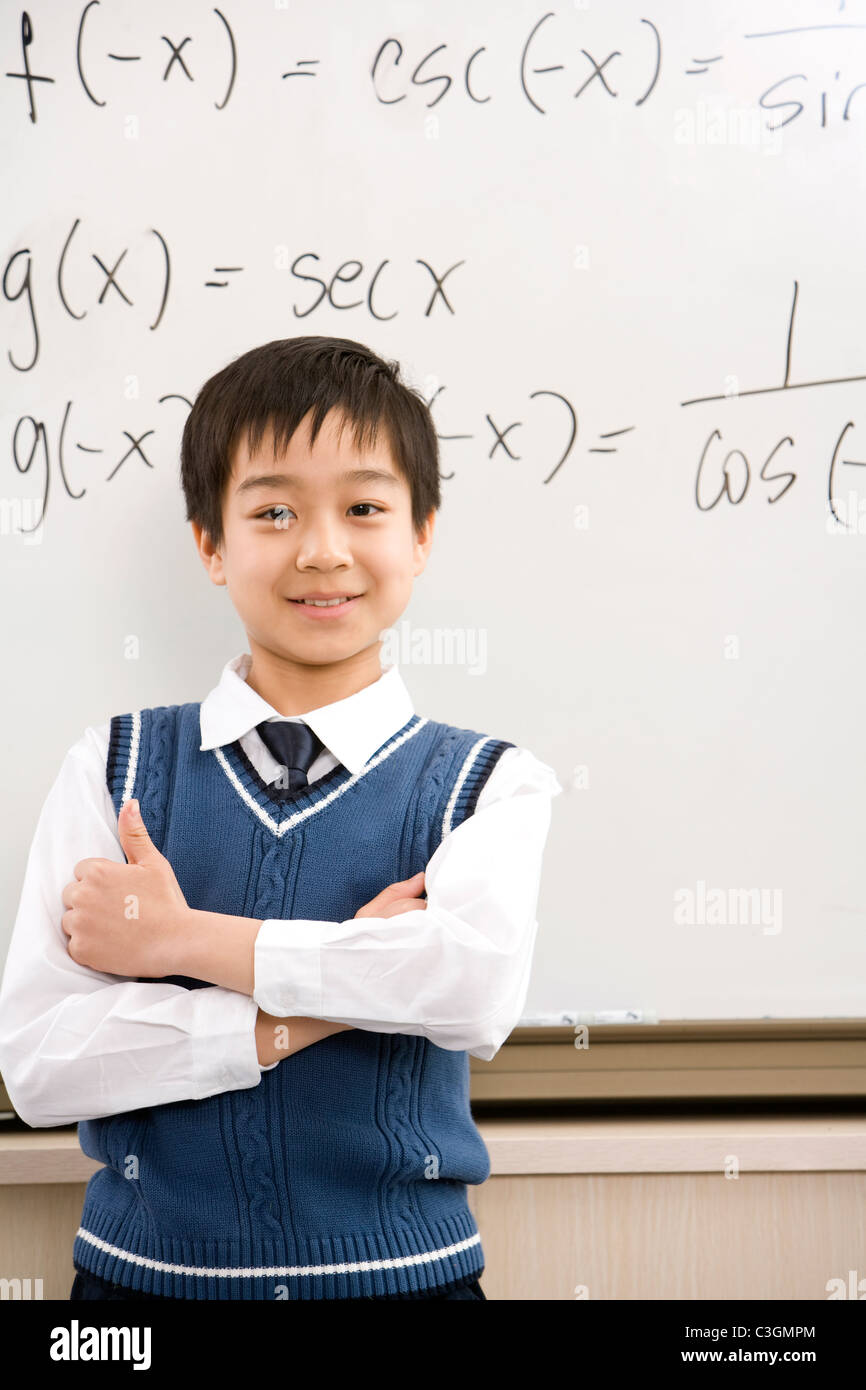 Confident student standing in front of math work Stock Photo - Alamy