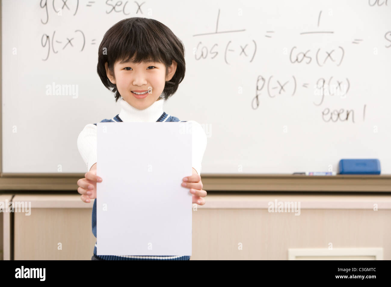 Confident student standing in front of math work Stock Photo - Alamy
