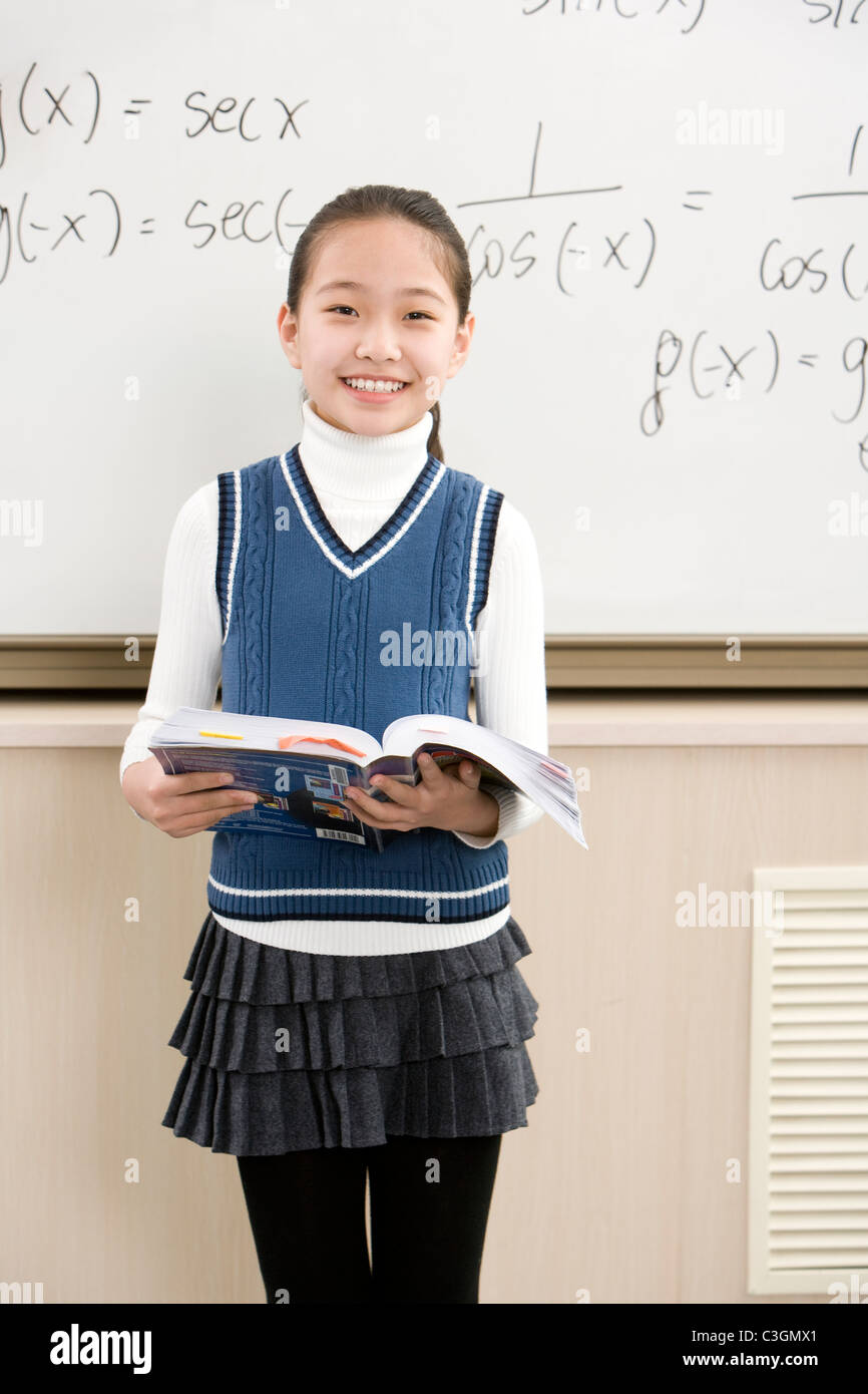 Confident student standing in front of math work Stock Photo - Alamy