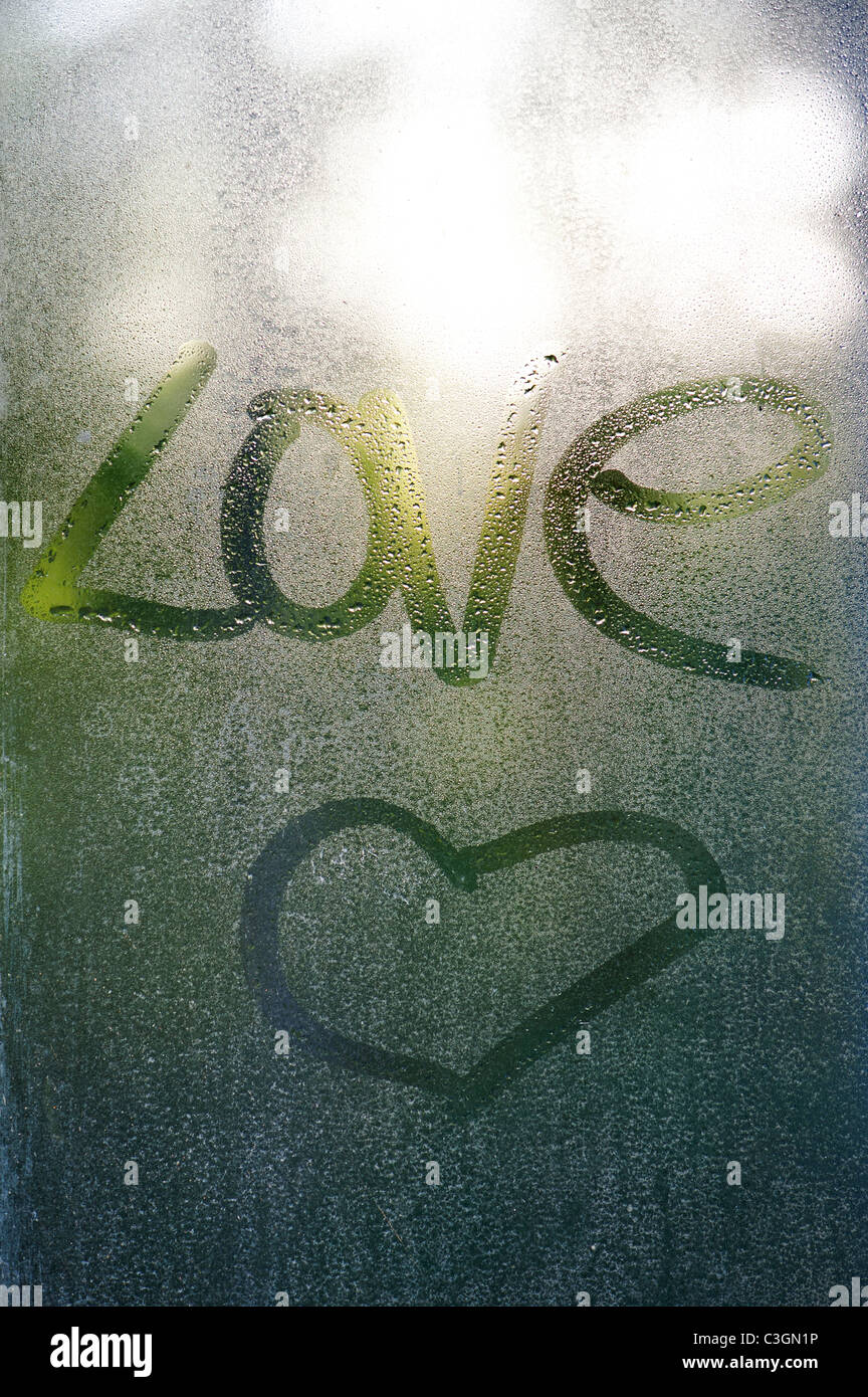 Love written in condensation on a glass window pane Stock Photo - Alamy