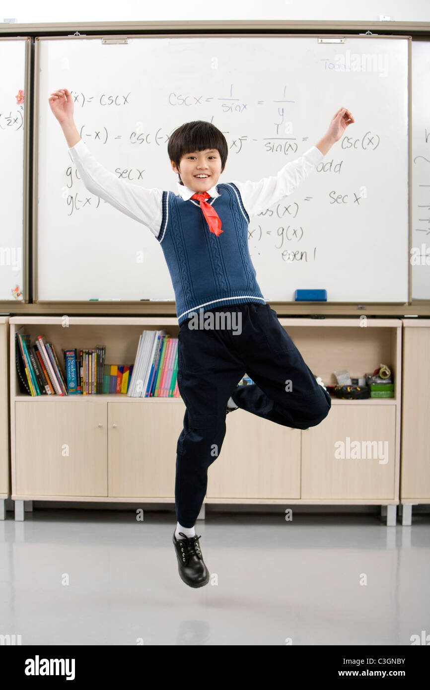 Young student jumping in front of whiteboard Stock Photo - Alamy
