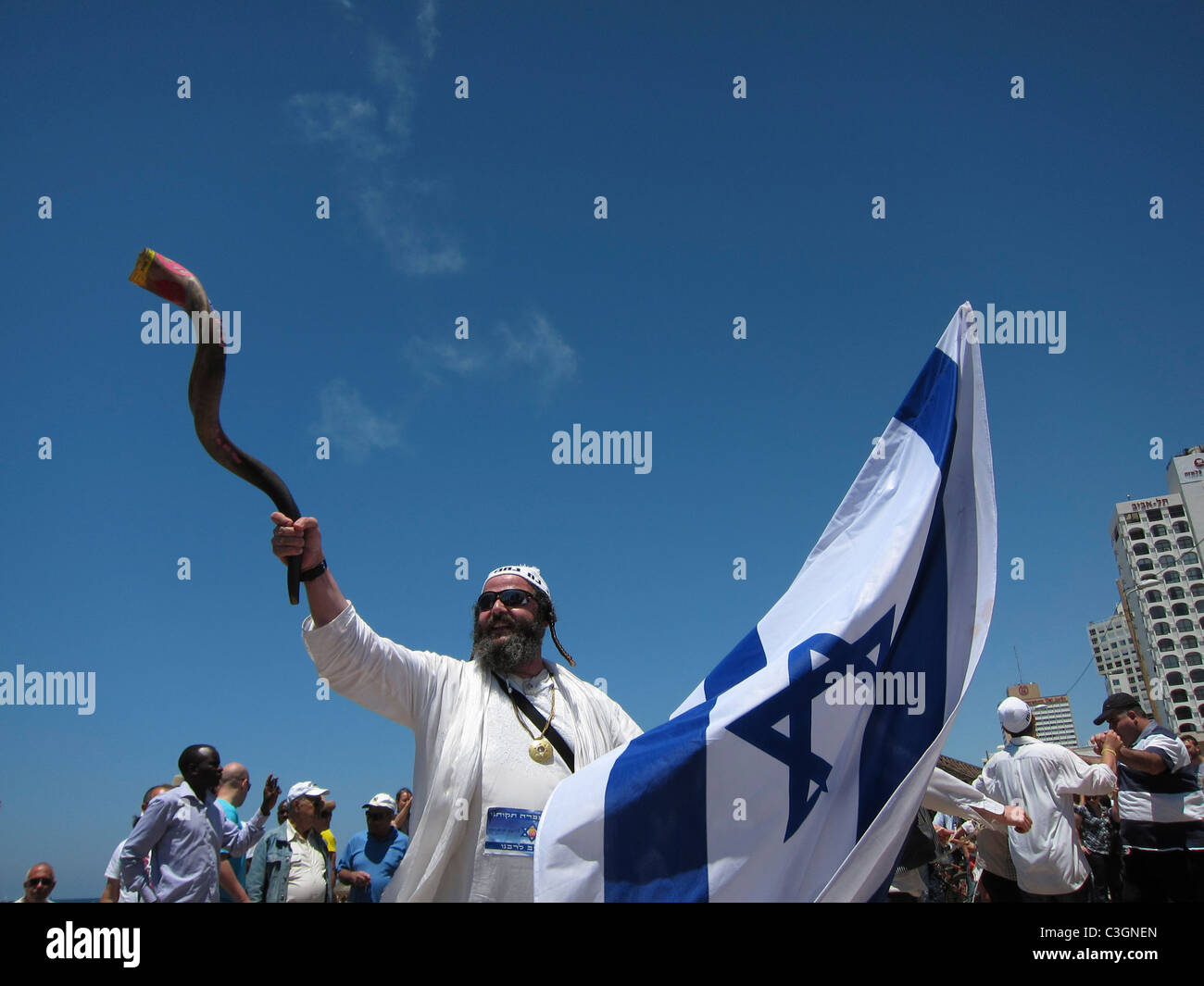 A religious Jewish man dance while waving Israeli flag at the seacoast ...