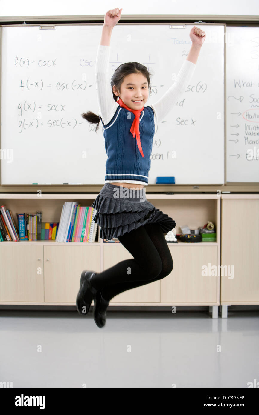 Young student jumping in front of whiteboard Stock Photo - Alamy