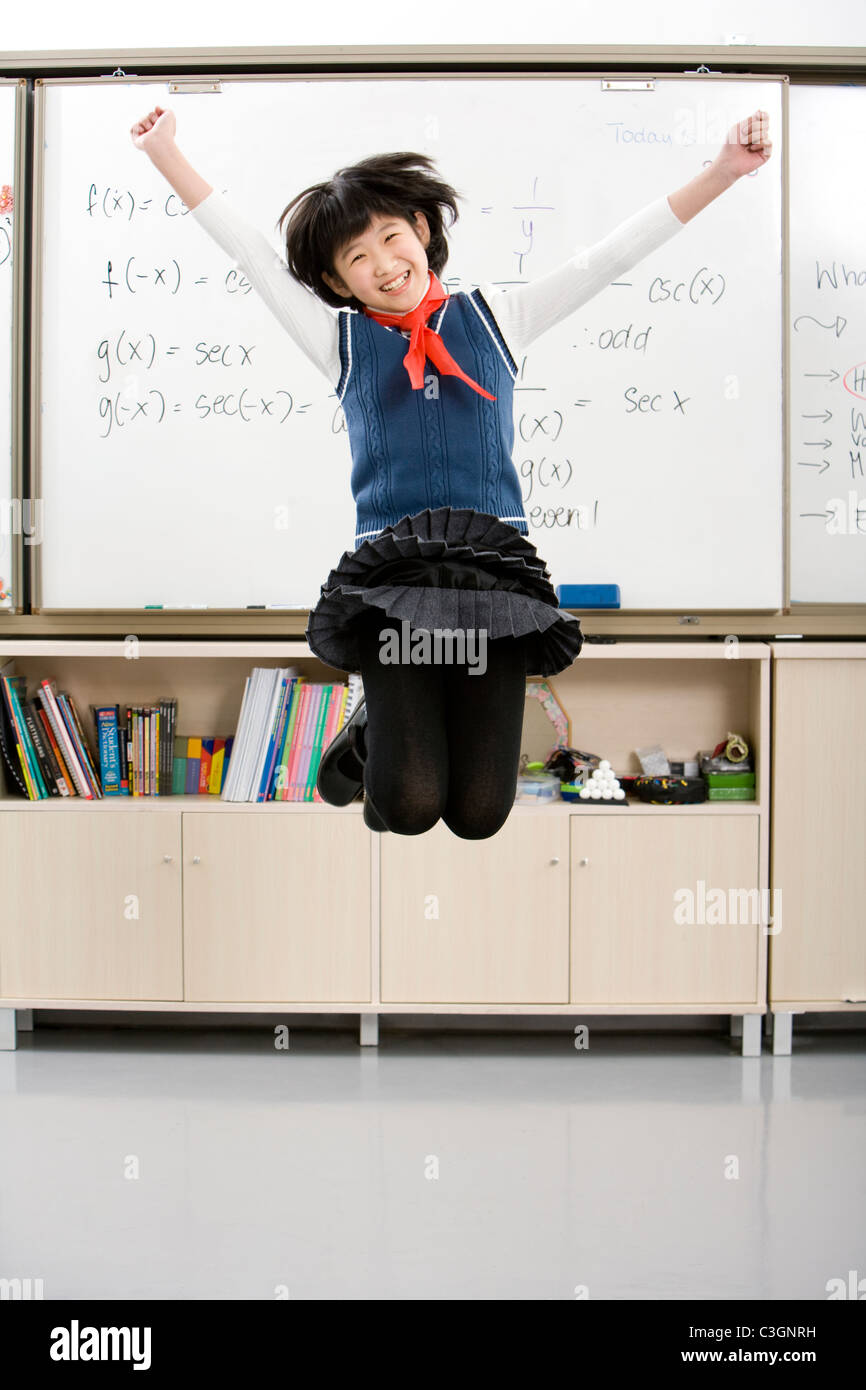 Young student jumping in front of whiteboard Stock Photo - Alamy