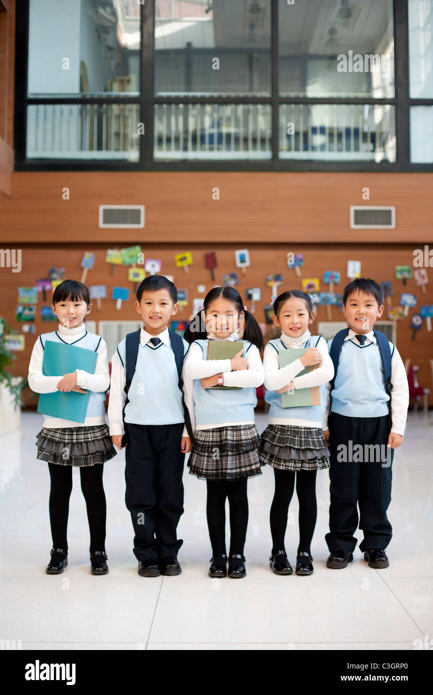 Young students standing in a row at school Stock Photo - Alamy