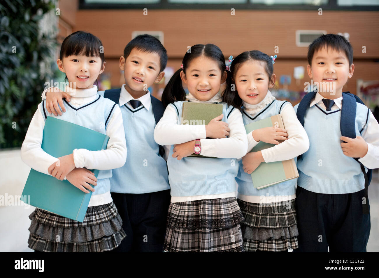 Young students standing in a row at school Stock Photo - Alamy