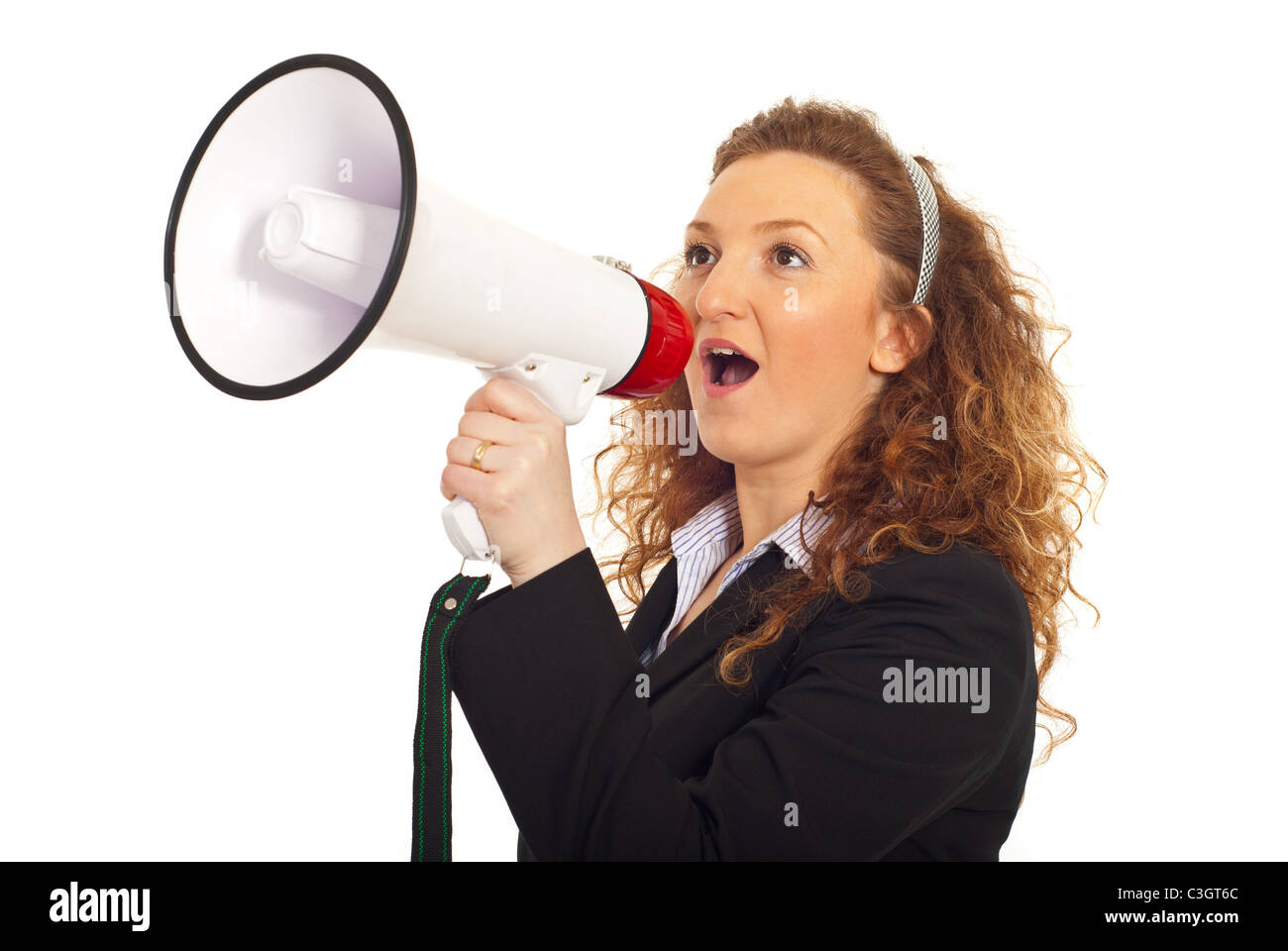Business woman shouting into loudspeaker and standing in semi profile ...