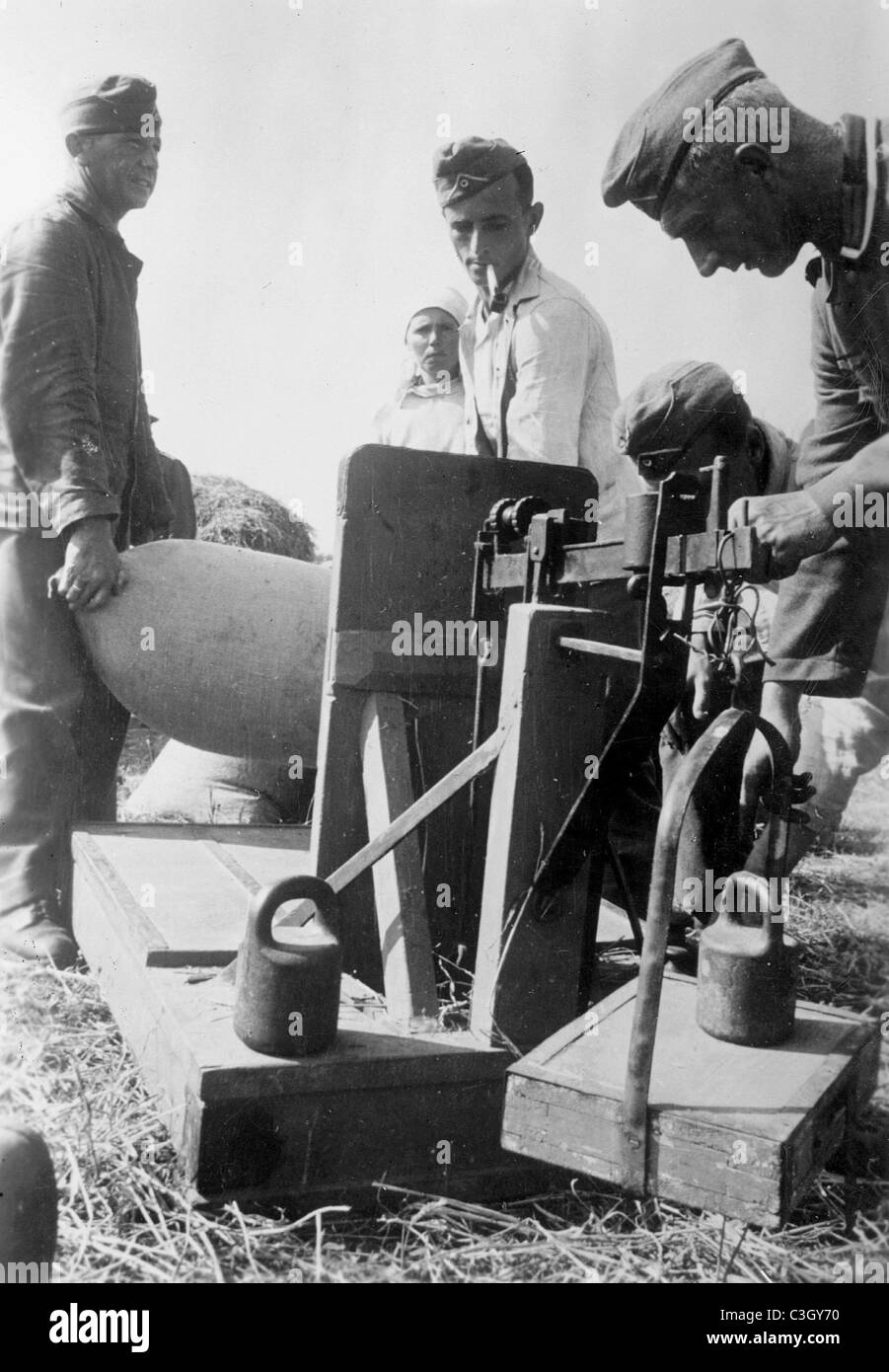 German soldiers with a peasant woman during the grain harvest on the ...