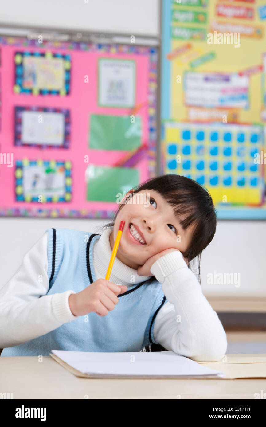 Young student thinking in classroom Stock Photo - Alamy
