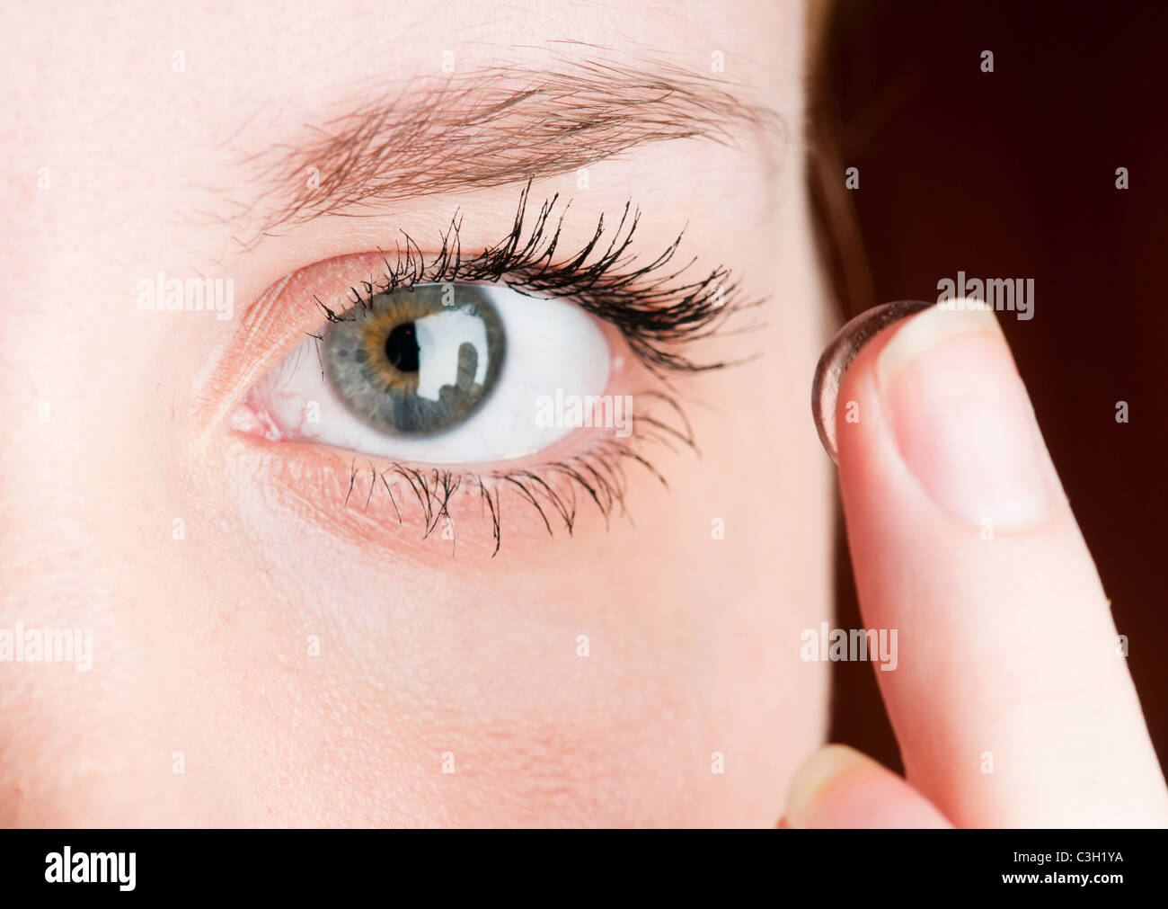 Close up of inserting a contact lens in female eye Stock Photo - Alamy