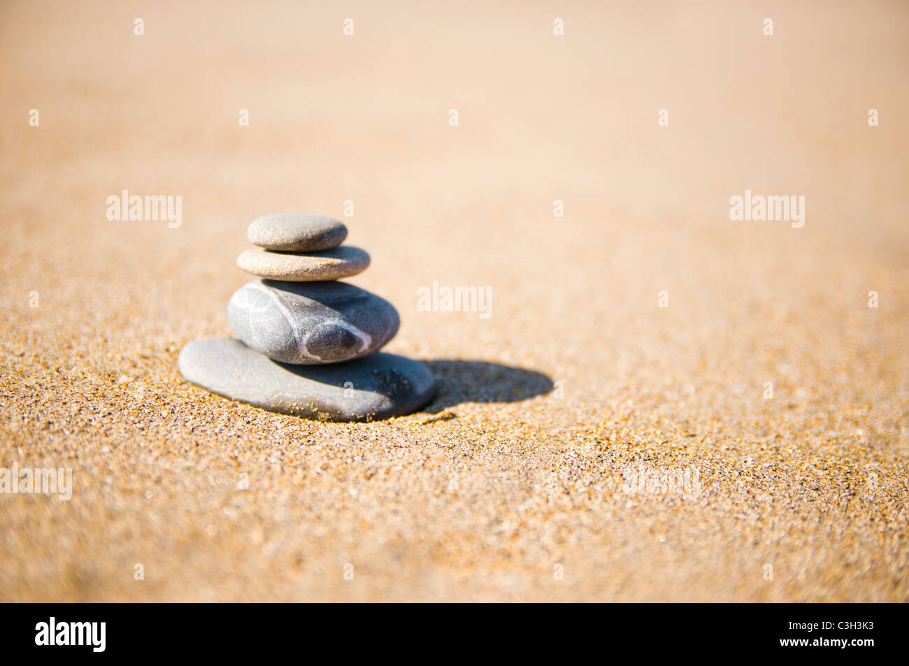 stones stacked up on beach Stock Photo - Alamy