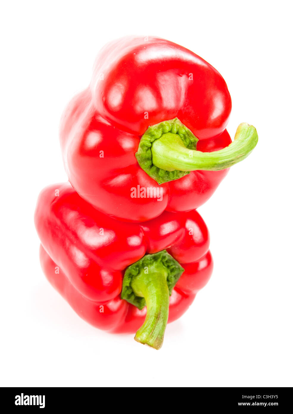 two fresh red peppers on white Stock Photo - Alamy