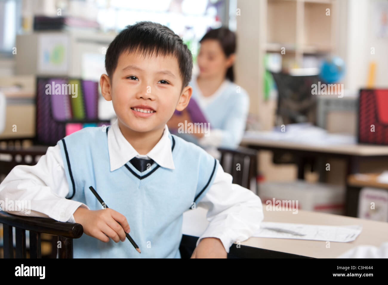 Young student smiling in class Stock Photo - Alamy