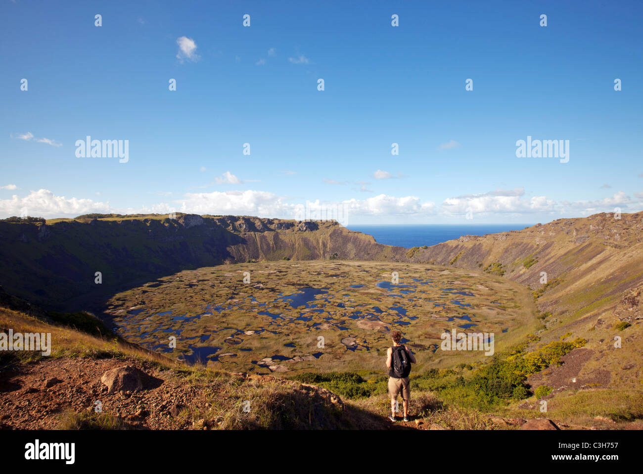 Tourist viewing Rano Kau, an extinct volcano crater near Orongo village ...