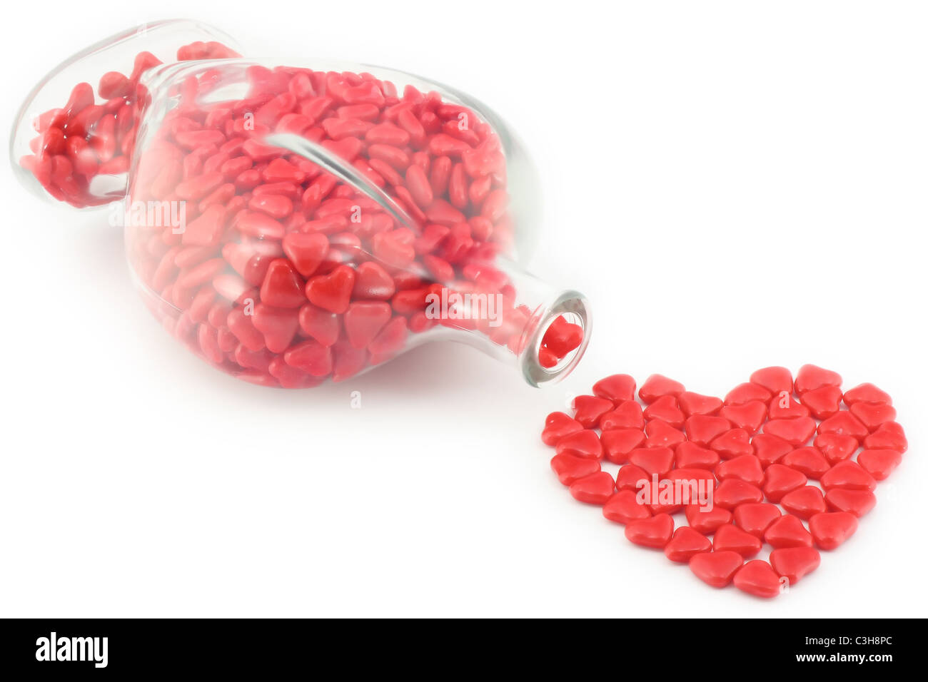 Bottle of Valentine's candies spilled in to a heart shaped design Stock ...