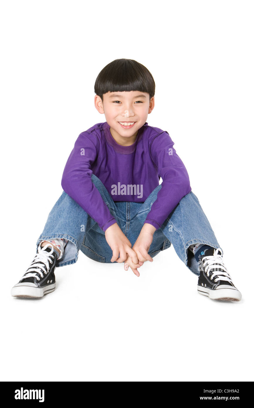 Children sitting on the ground Cut Out Stock Images & Pictures - Alamy