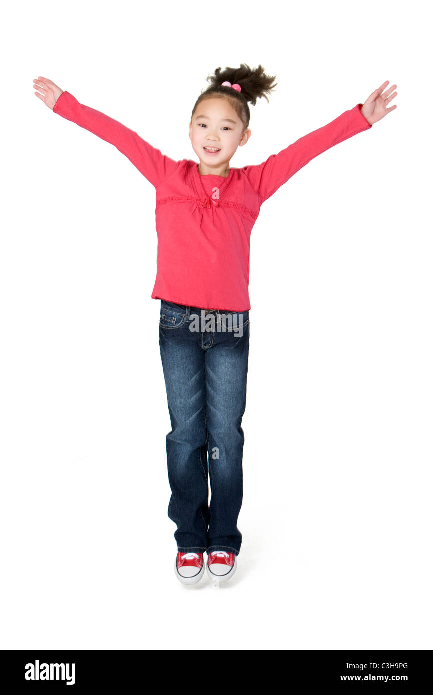 Excited young girl jumping up Stock Photo - Alamy