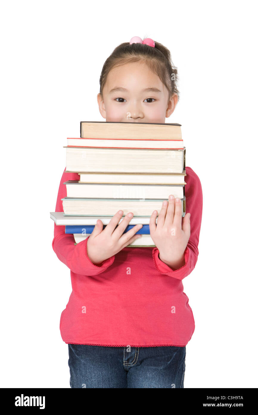 Cute school girl carrying stack hi-res stock photography and images - Alamy