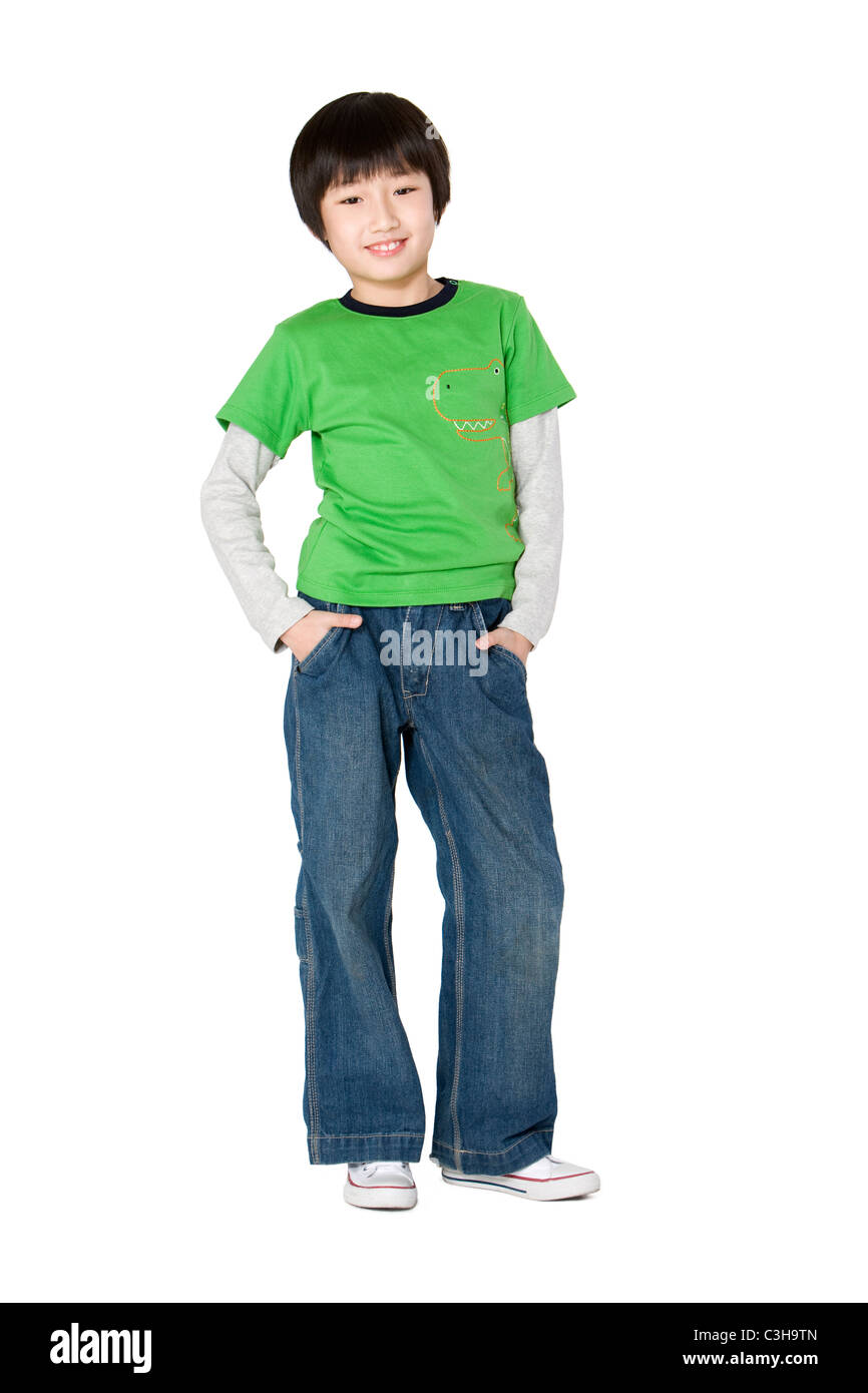 Young boy standing with hands in pockets Stock Photo - Alamy