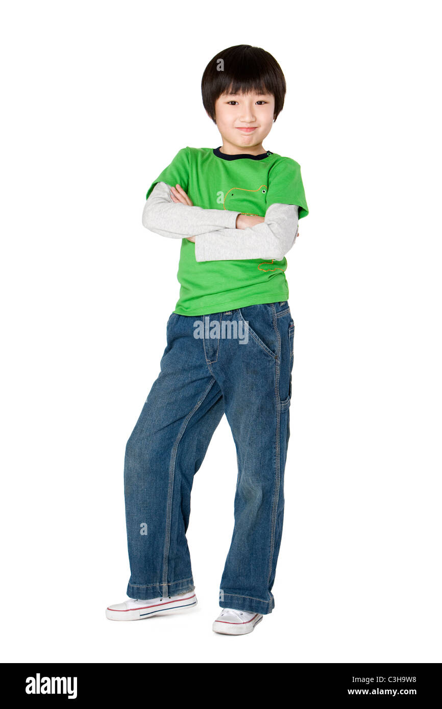 Young boy standing with arms crossed Stock Photo - Alamy