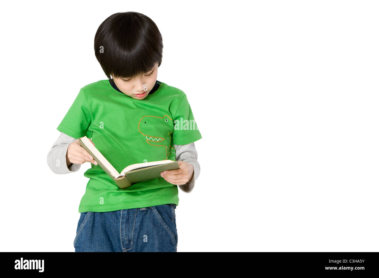 Young boy reading a book Stock Photo - Alamy