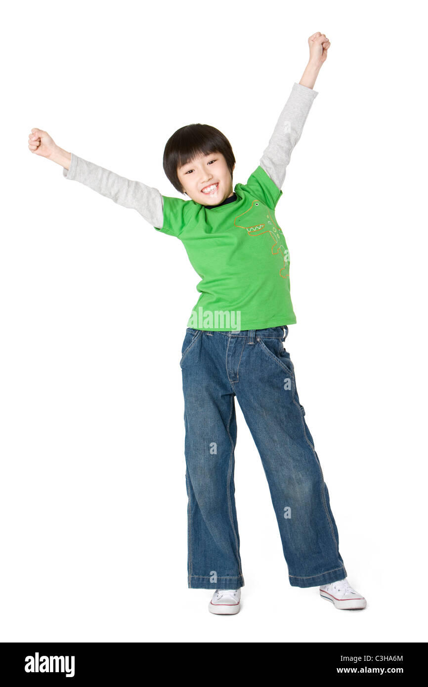 Young boy raising his arms in excitement Stock Photo - Alamy