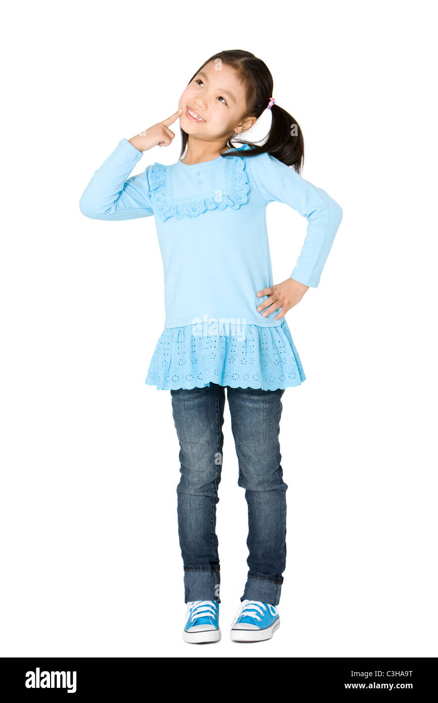 Young girl happily thinking with hands on hip Stock Photo - Alamy