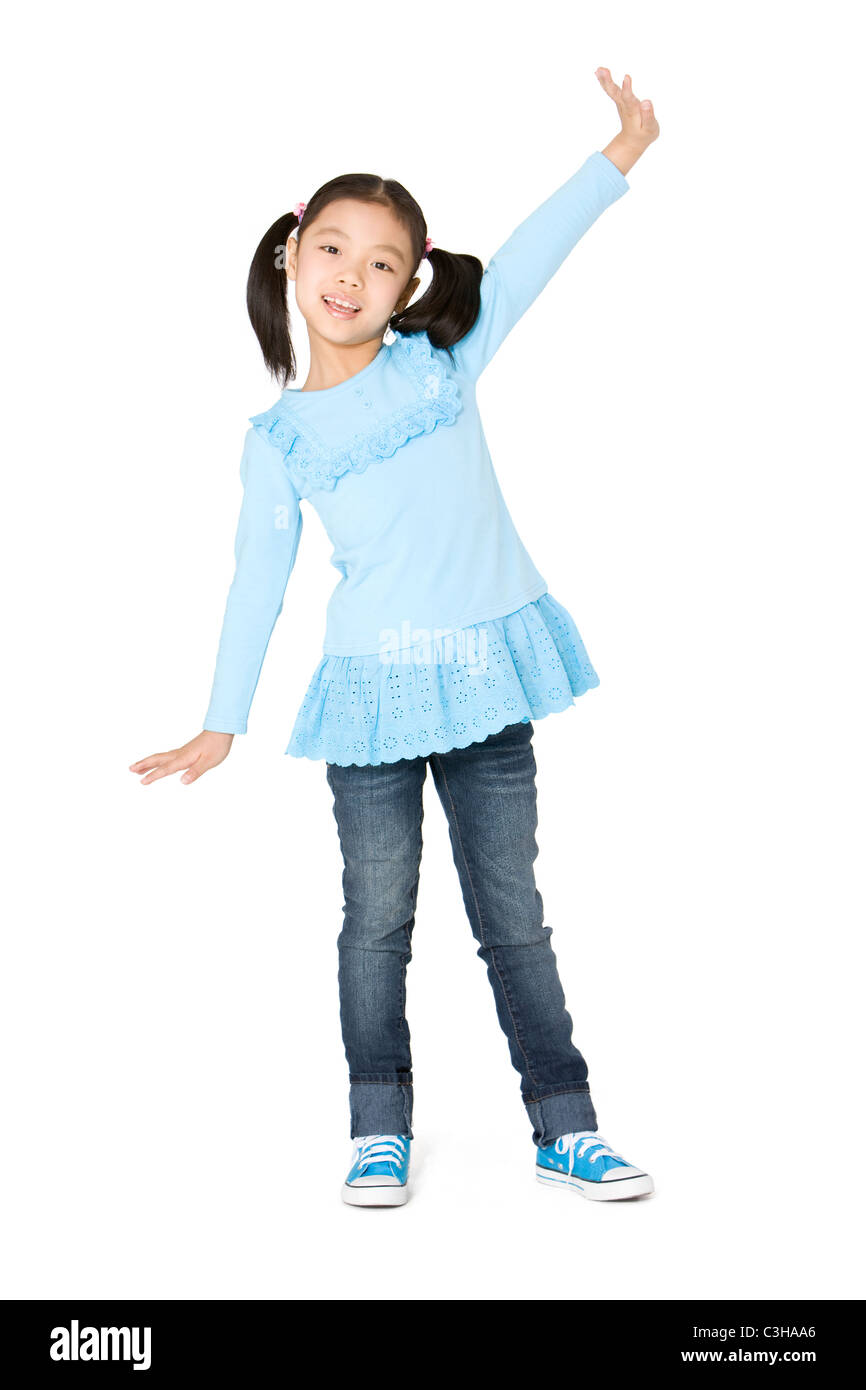 Young girl standing with arms raised Stock Photo - Alamy