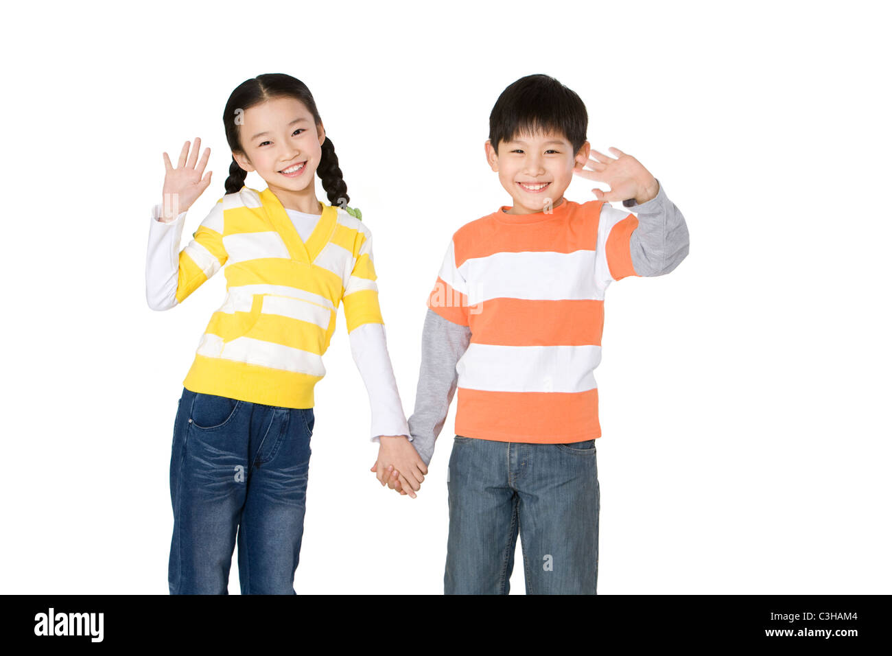 Two friends waving while holding hands Stock Photo - Alamy