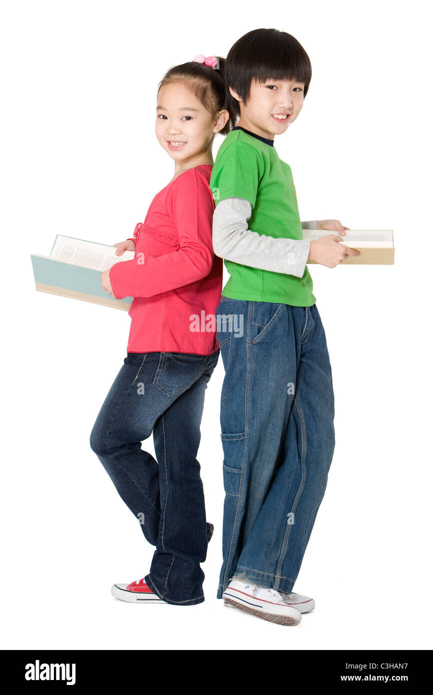 Two students reading back to back Stock Photo - Alamy