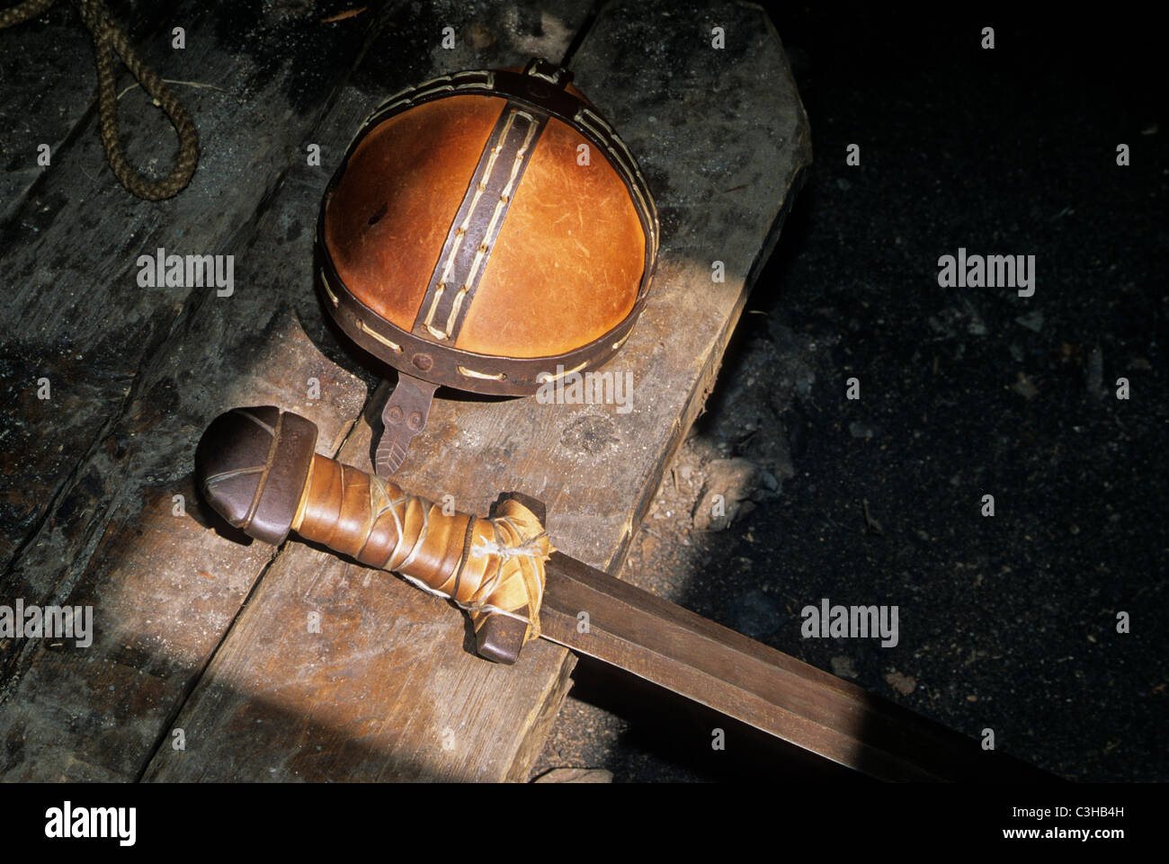 Viking helmet and sword on wooden bench Stock Photo - Alamy